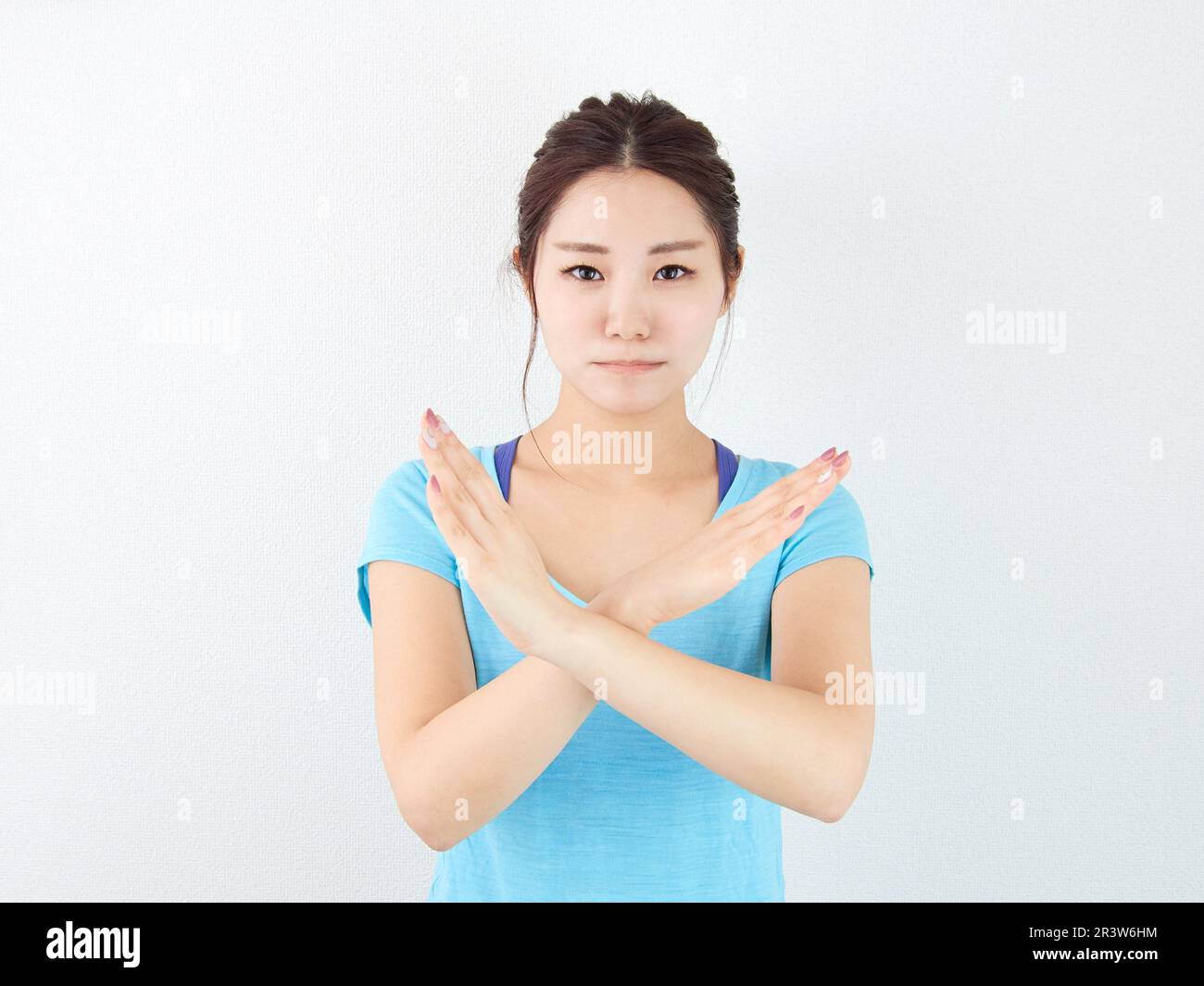 Asian women giving bad signs in sportswear Stock Photo - Alamy