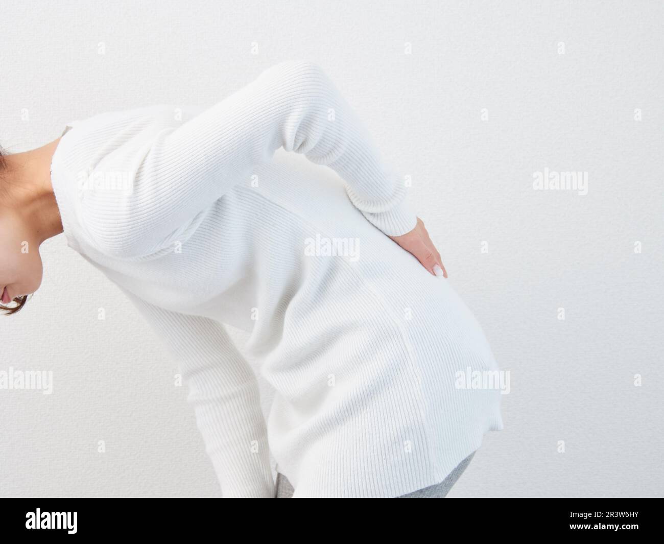 Asian woman suffering from back pain Stock Photo - Alamy