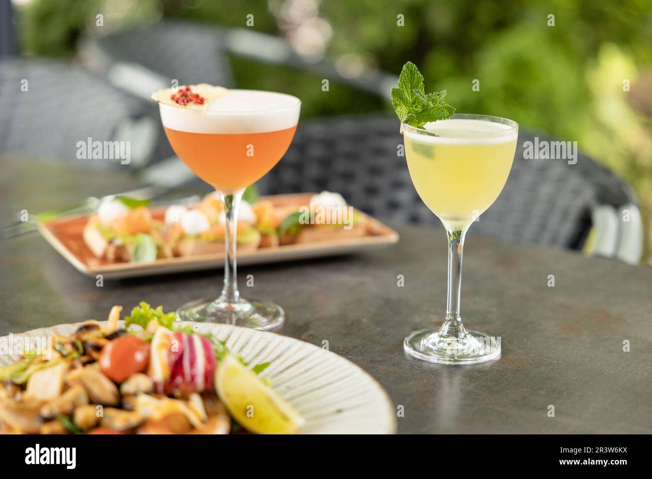 Seafood aperitif served with cutlery and two cocktails in the ...