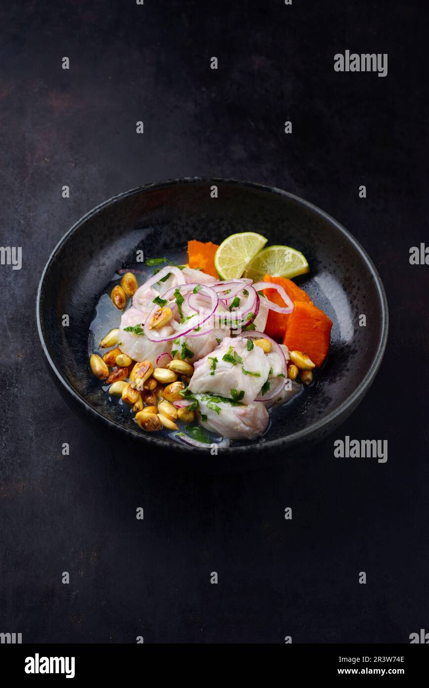 Traditional Peruvian gourmet ceviche sea bass filet piece with sweet ...