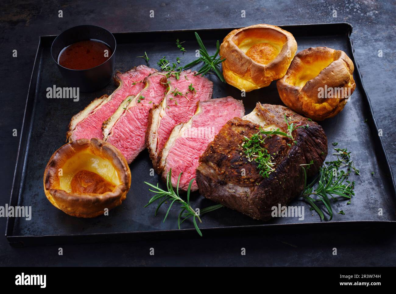 Traditional Commonwealth Sunday roast beef sliced with Yorkshire ...