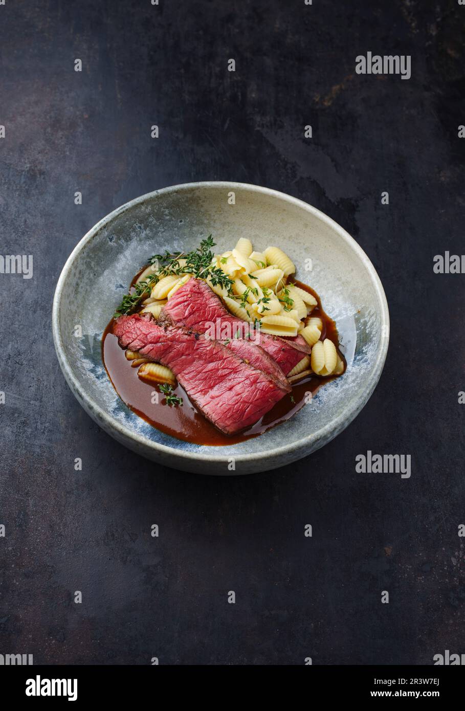 Traditional Italian chianina sliced roast beef with gnocchetti sardi ...