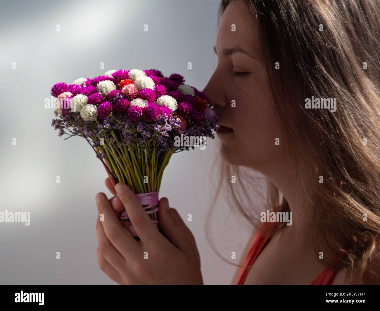 Lady smells flowers hi-res stock photography and images - Alamy