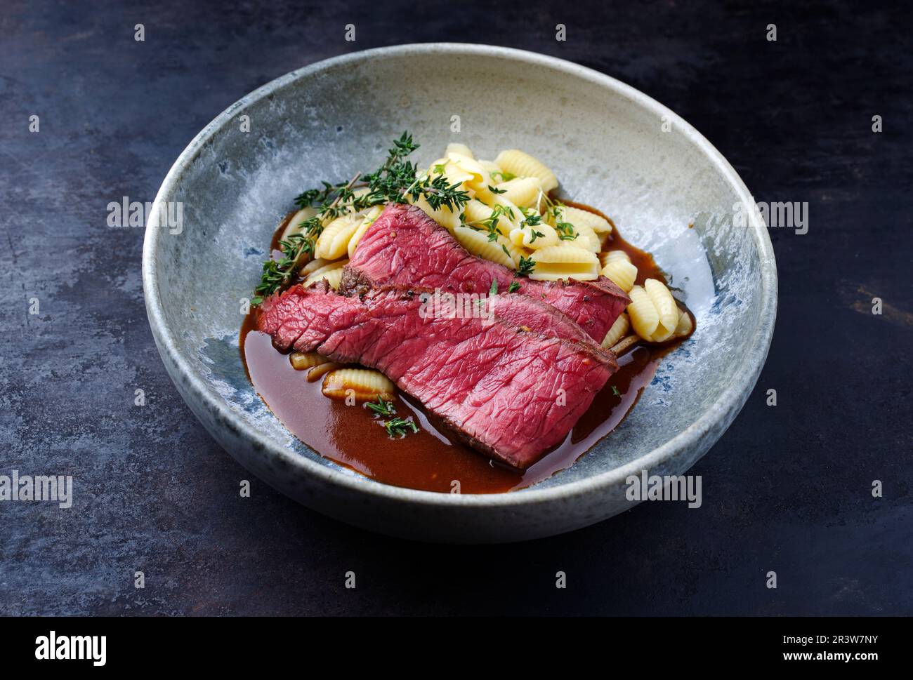 Traditional Italian chianina sliced roast beef with gnocchetti sardi ...