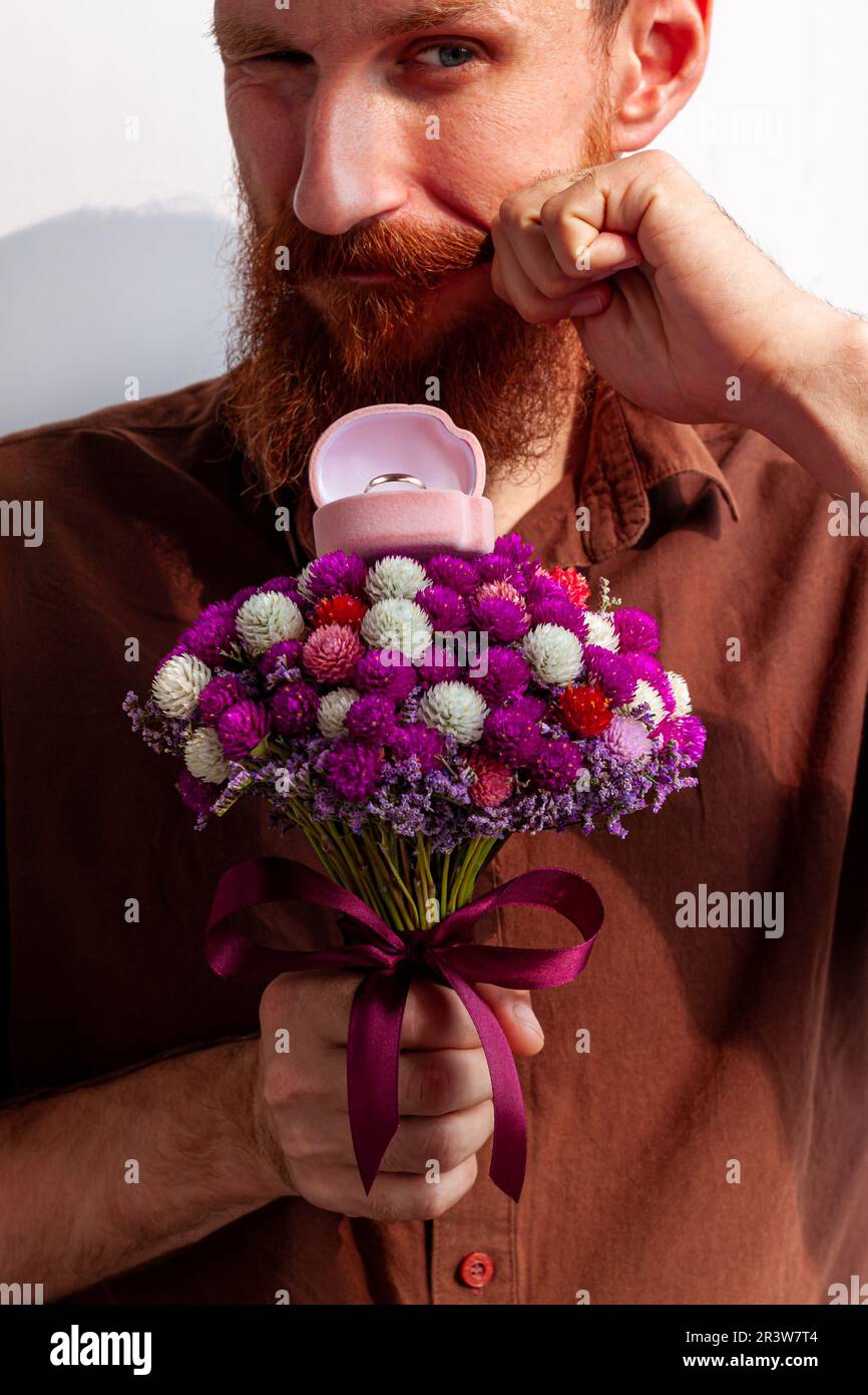 Handsome guy holding flowers hi-res stock photography and images - Alamy