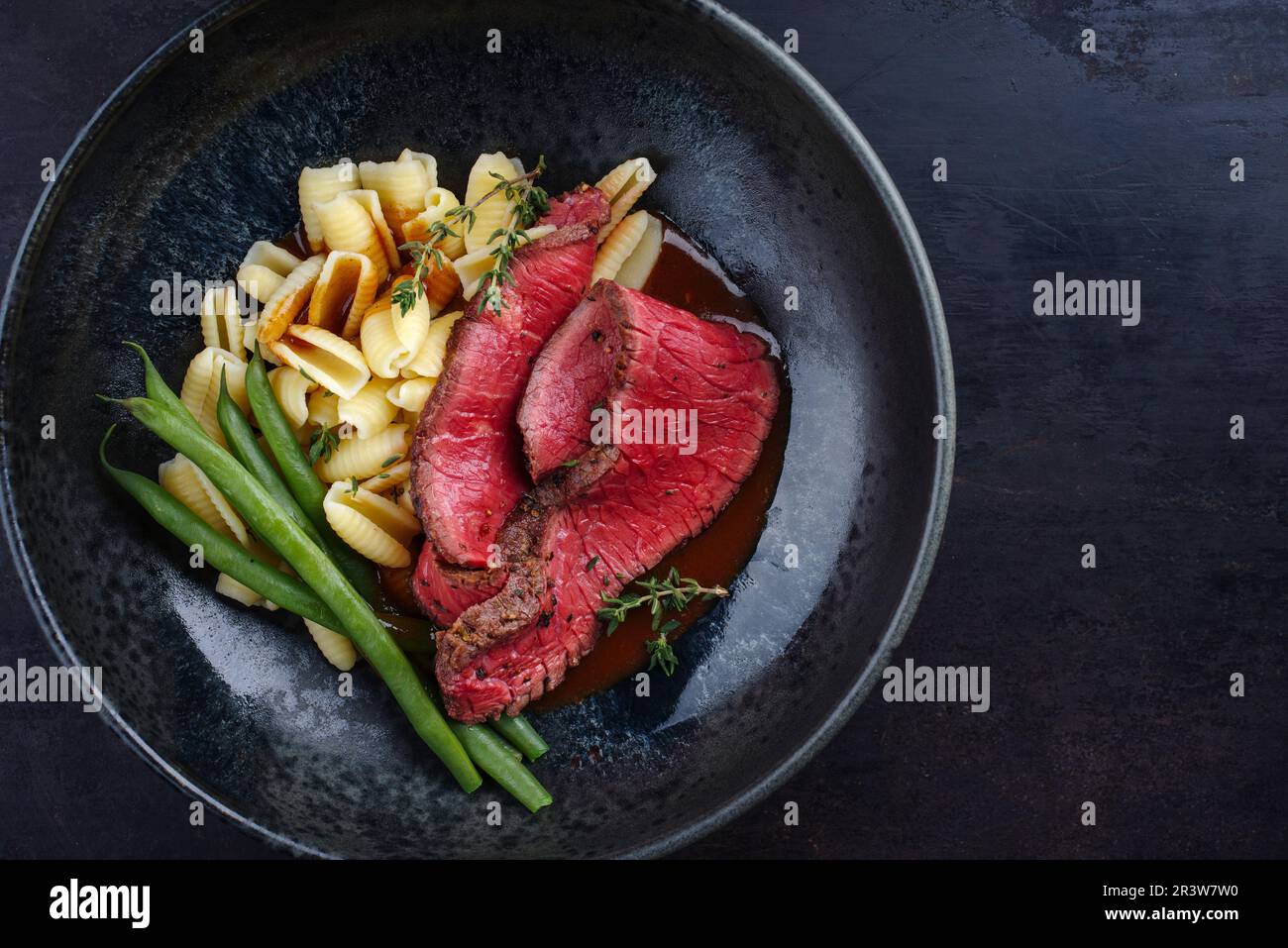 Traditional Italian chianina sliced roast beef with gnocchetti sardi ...