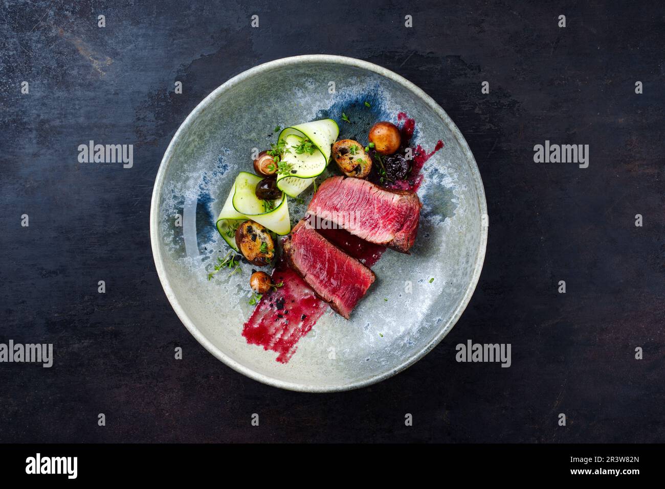 Fried Italian chianina beef fillet steak very rare with mushrooms Stock ...