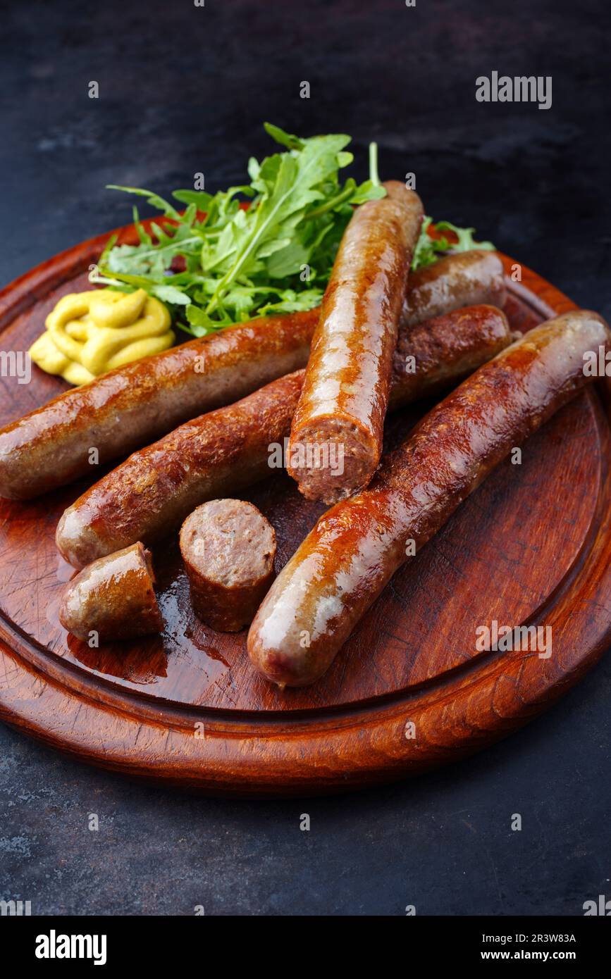 Fried AllgÃ¤u wagyu beef bratwurst with hot mustard and rocket lettuce ...