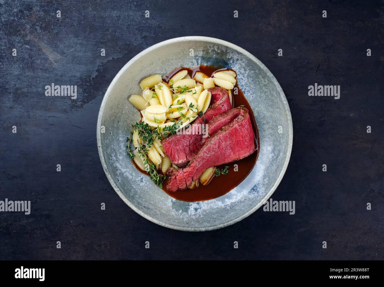 Traditional Italian chianina sliced roast beef with gnocchetti sardi ...