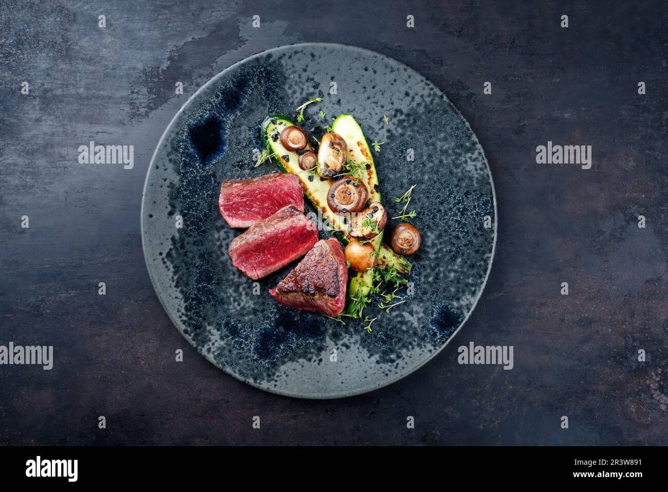 Fried Italian chianina beef fillet steak very rare with mushrooms and ...