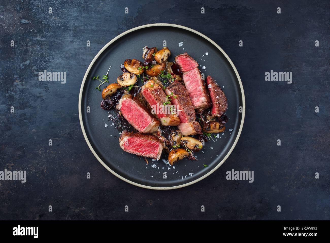 Modern style dry aged Wagyu rib eye beef steak with mushrooms in ...