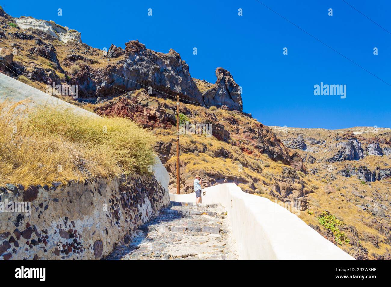 cliffside steps leading from fish restaurants on Korfos pebble beach ...