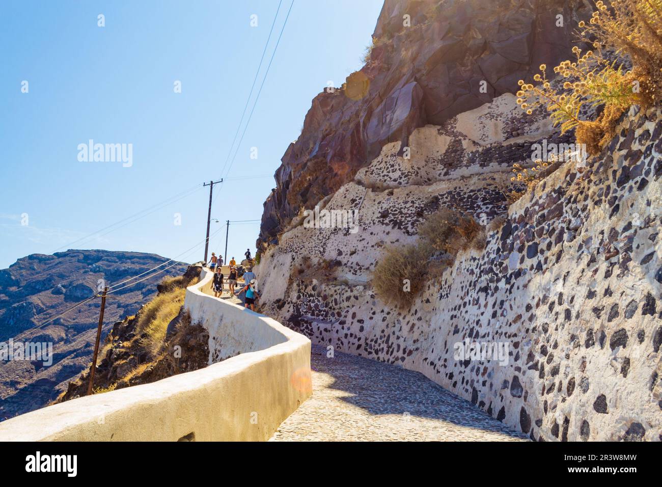 cliffside steps leading from fish restaurants on Korfos pebble beach ...