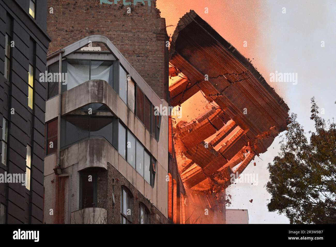 A wall collapses during a building fire in the Central Business ...