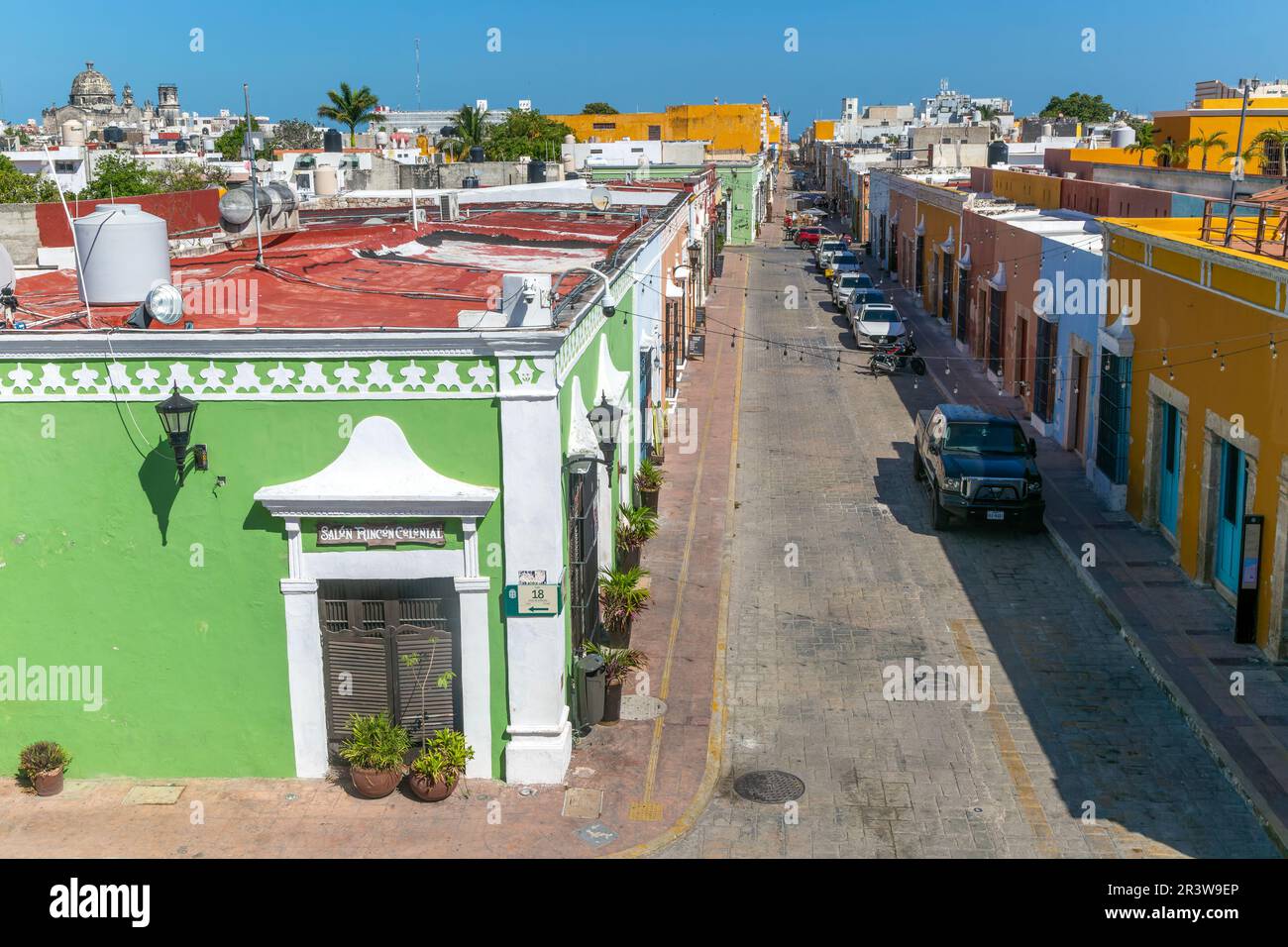 Raised view of street with cars parked and colourful Spanish colonial ...