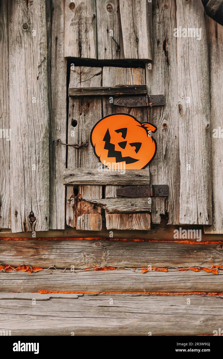 Halloween decor outdoors. Paper pumpkin on wooden building of the ...