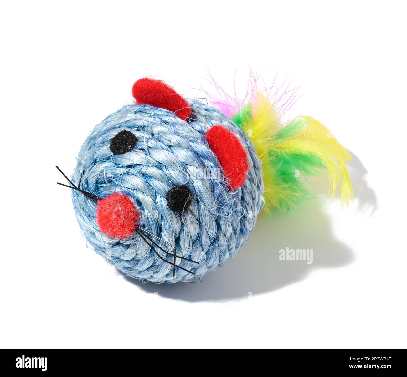 Round textile toy made of rope with feathers for animals on a white ...