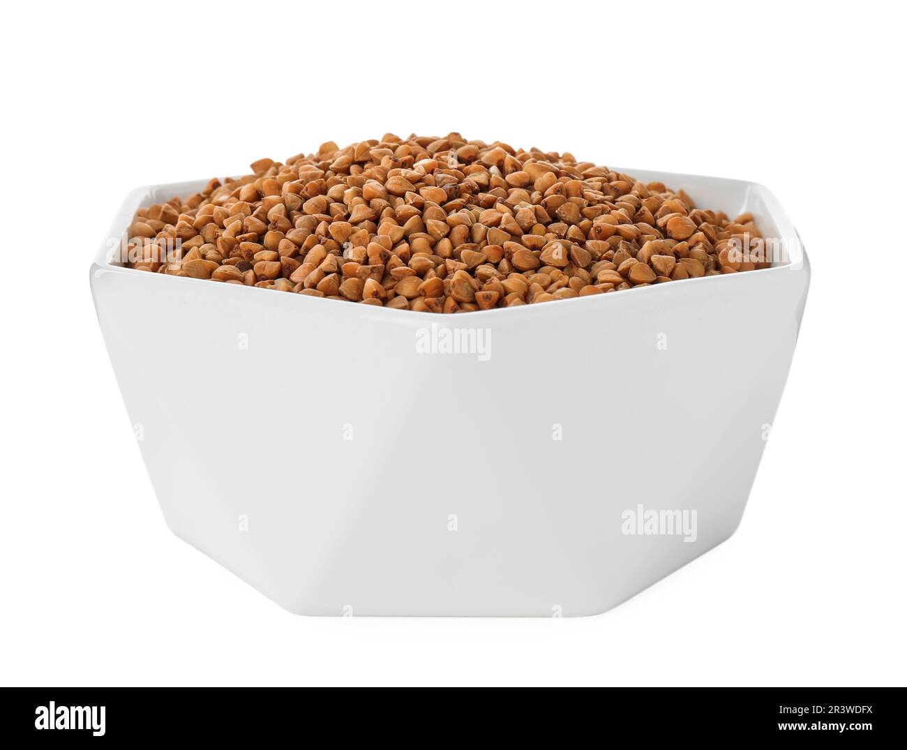 Uncooked buckwheat in bowl isolated on white Stock Photo - Alamy