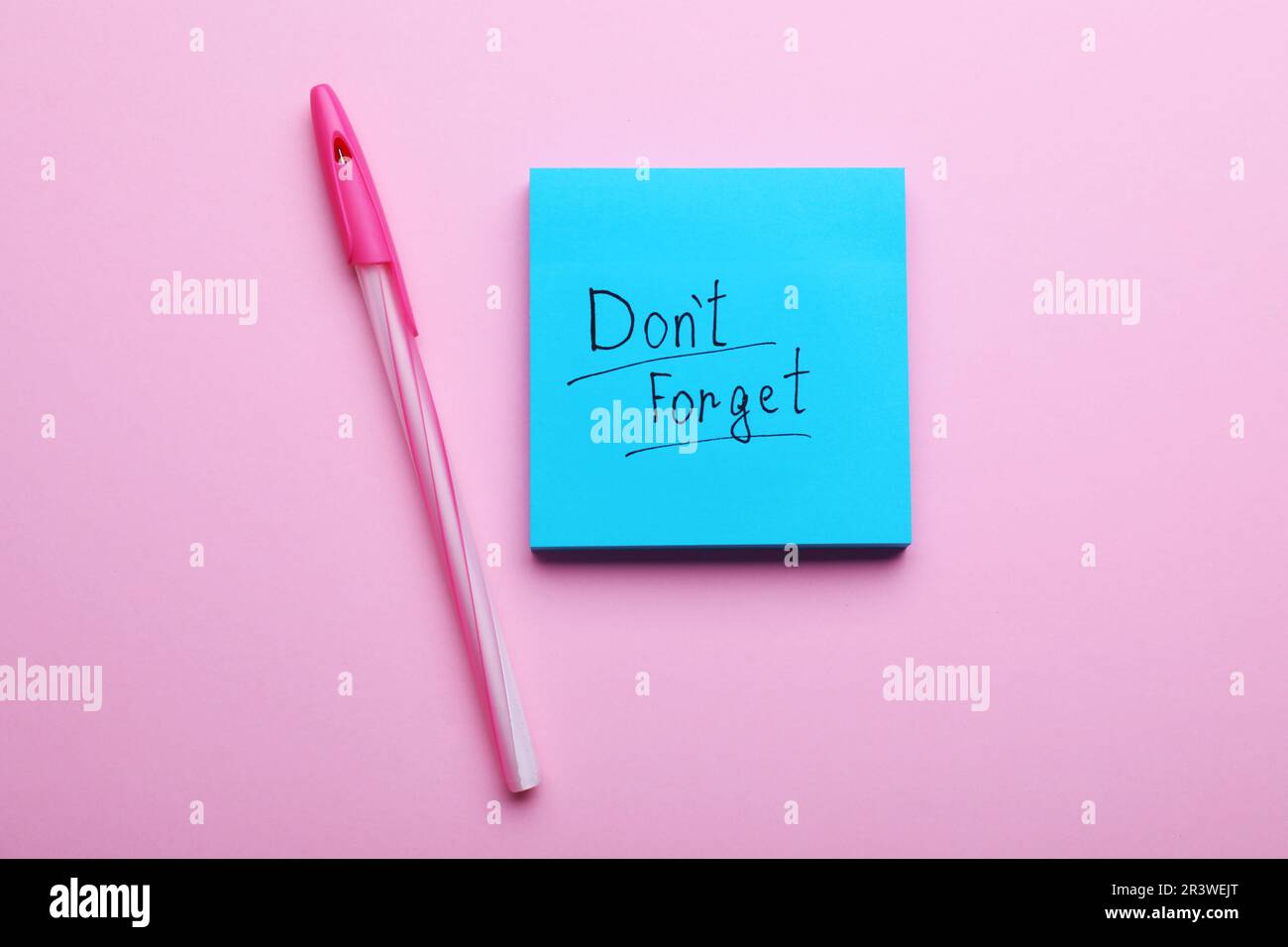 Paper note with phrase Don't Forget and pen on pink background, flat ...