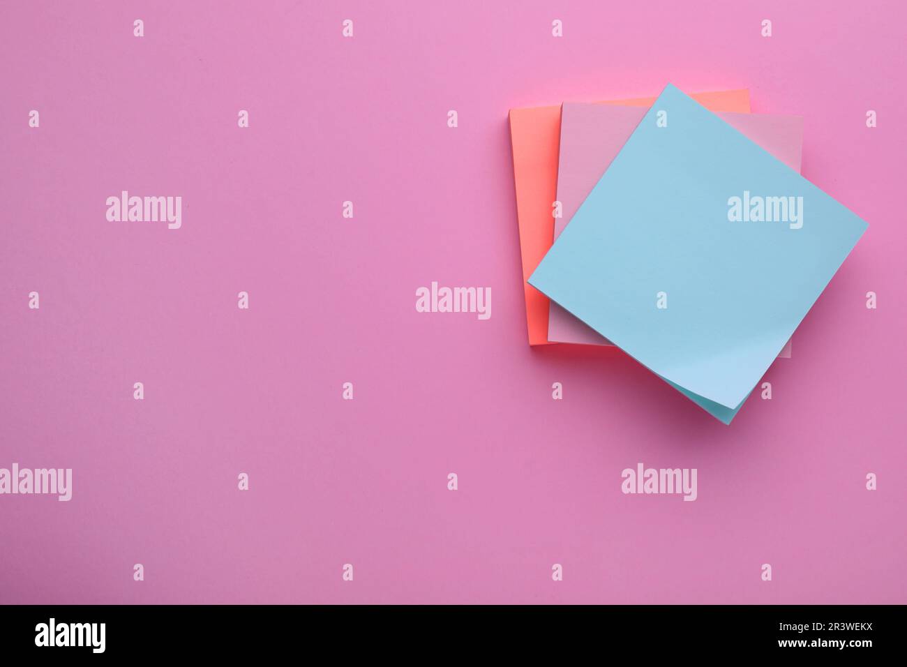 Paper notes on pale pink background, top view. Space for text Stock ...