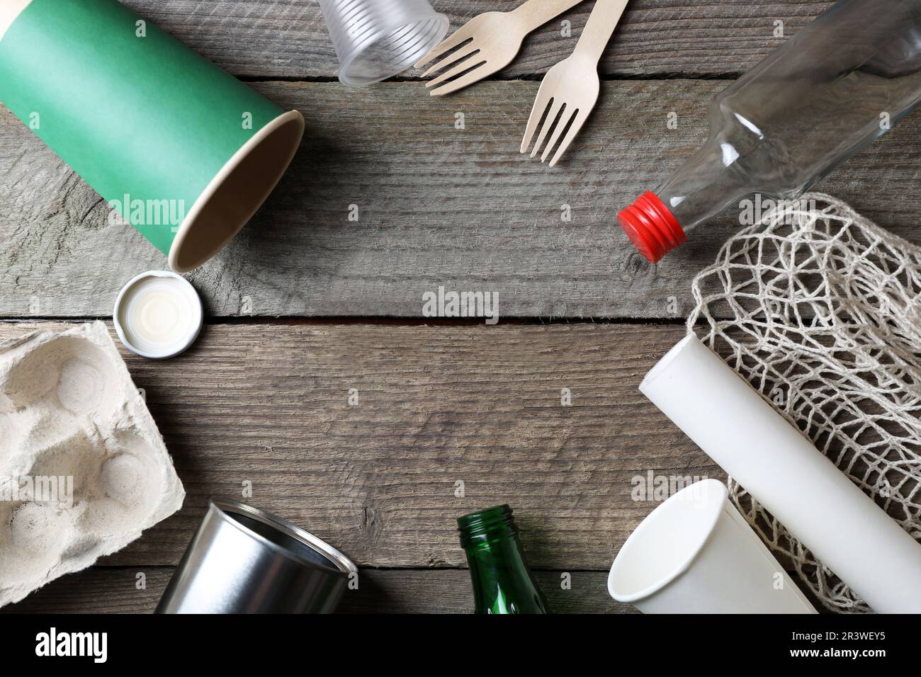 Recycling symbol and garbage on wooden table, flat lay Stock Photo - Alamy