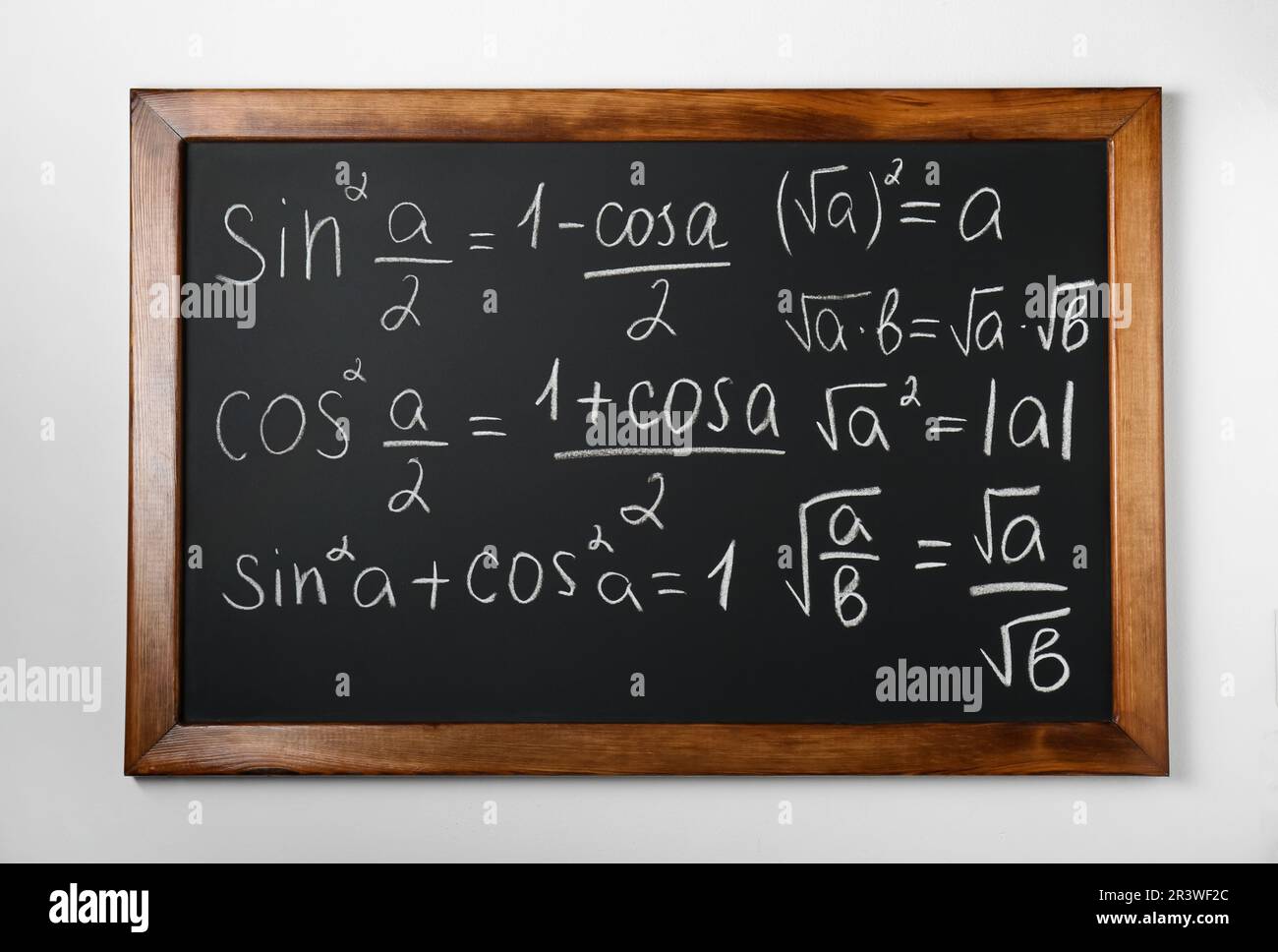 Blackboard with different mathematical formulas written with chalk on ...