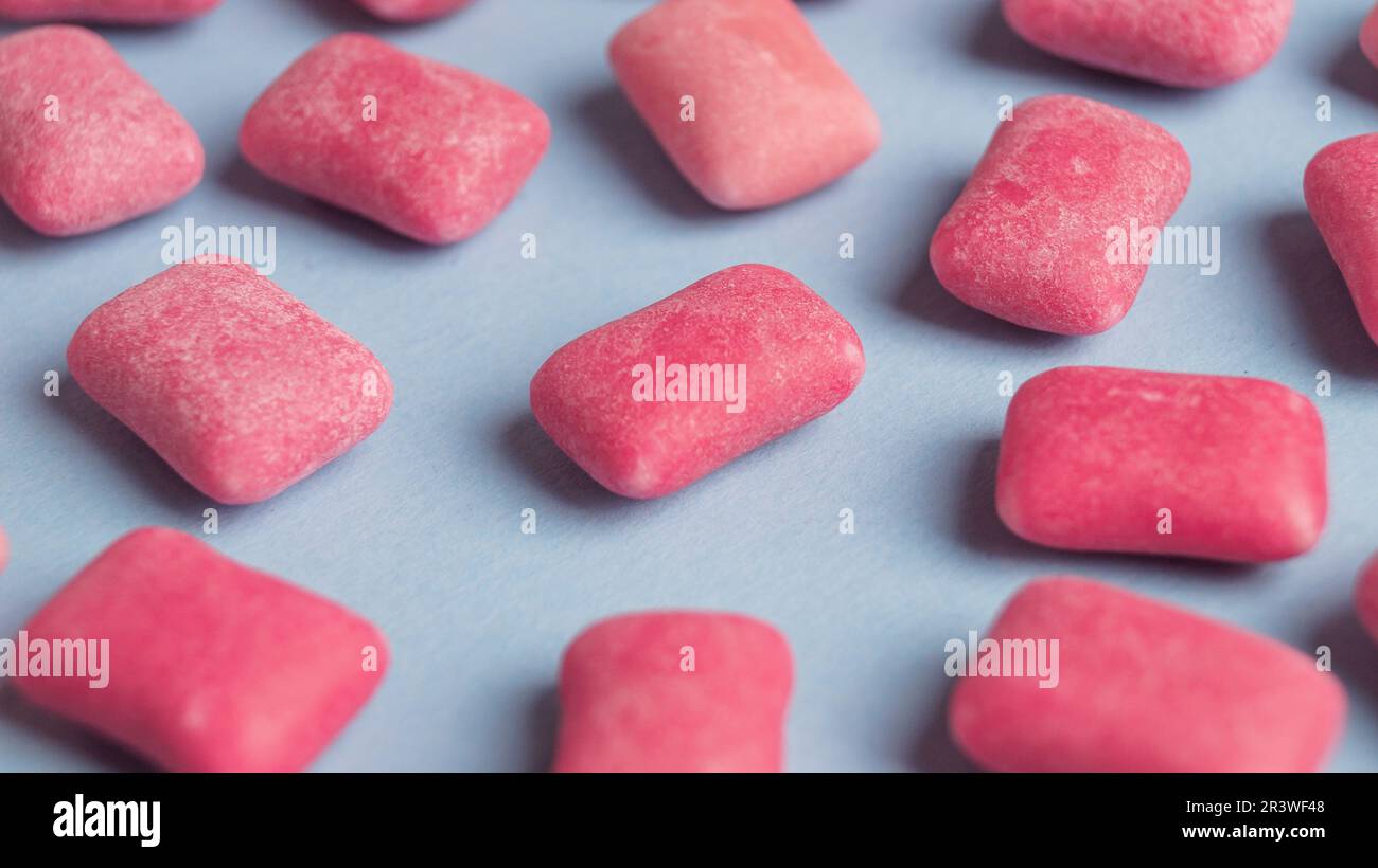 Many sweet chewing gums on light blue background, closeup Stock Photo ...
