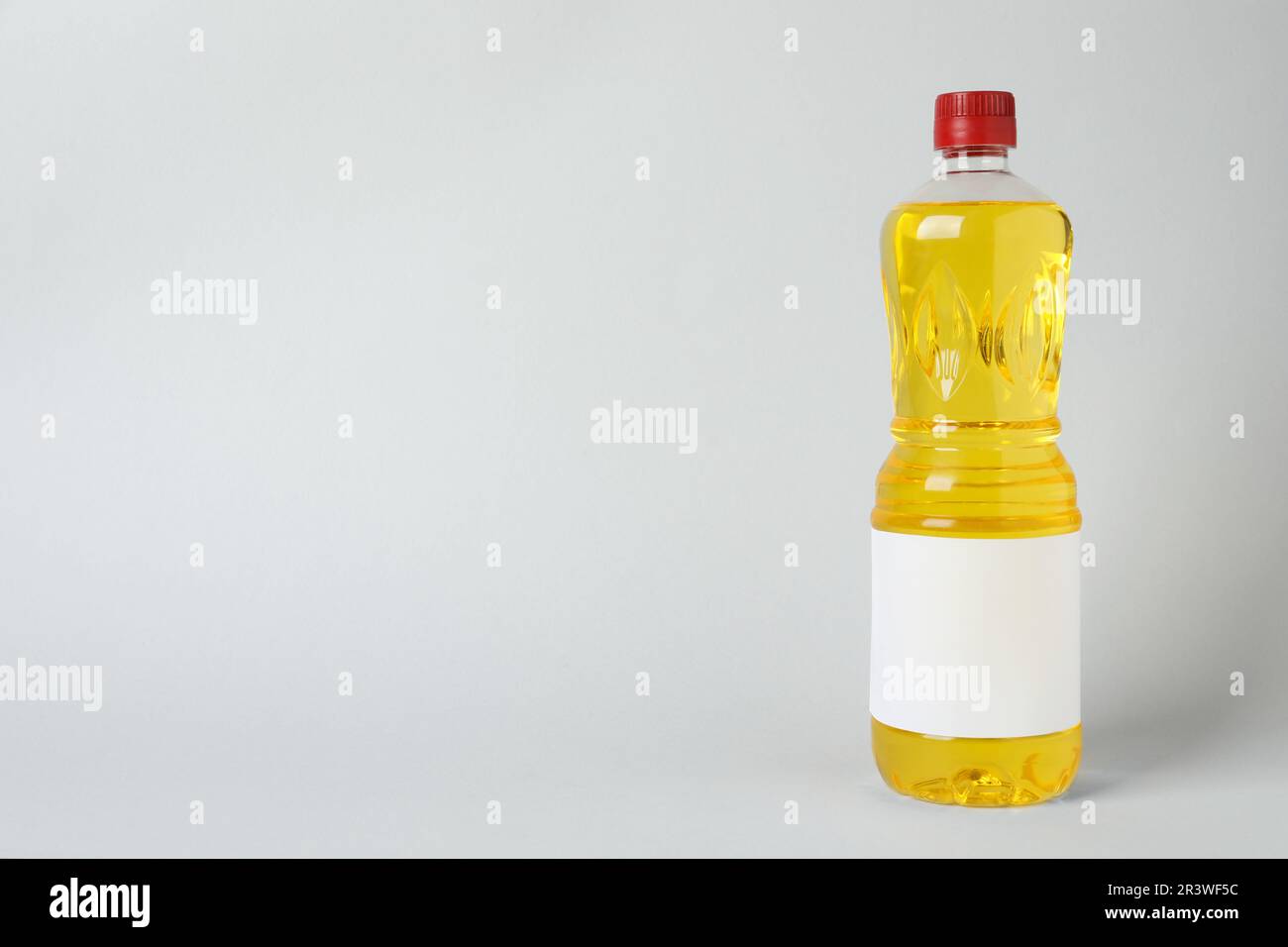 Bottle of cooking oil on light grey background. Space for text Stock ...