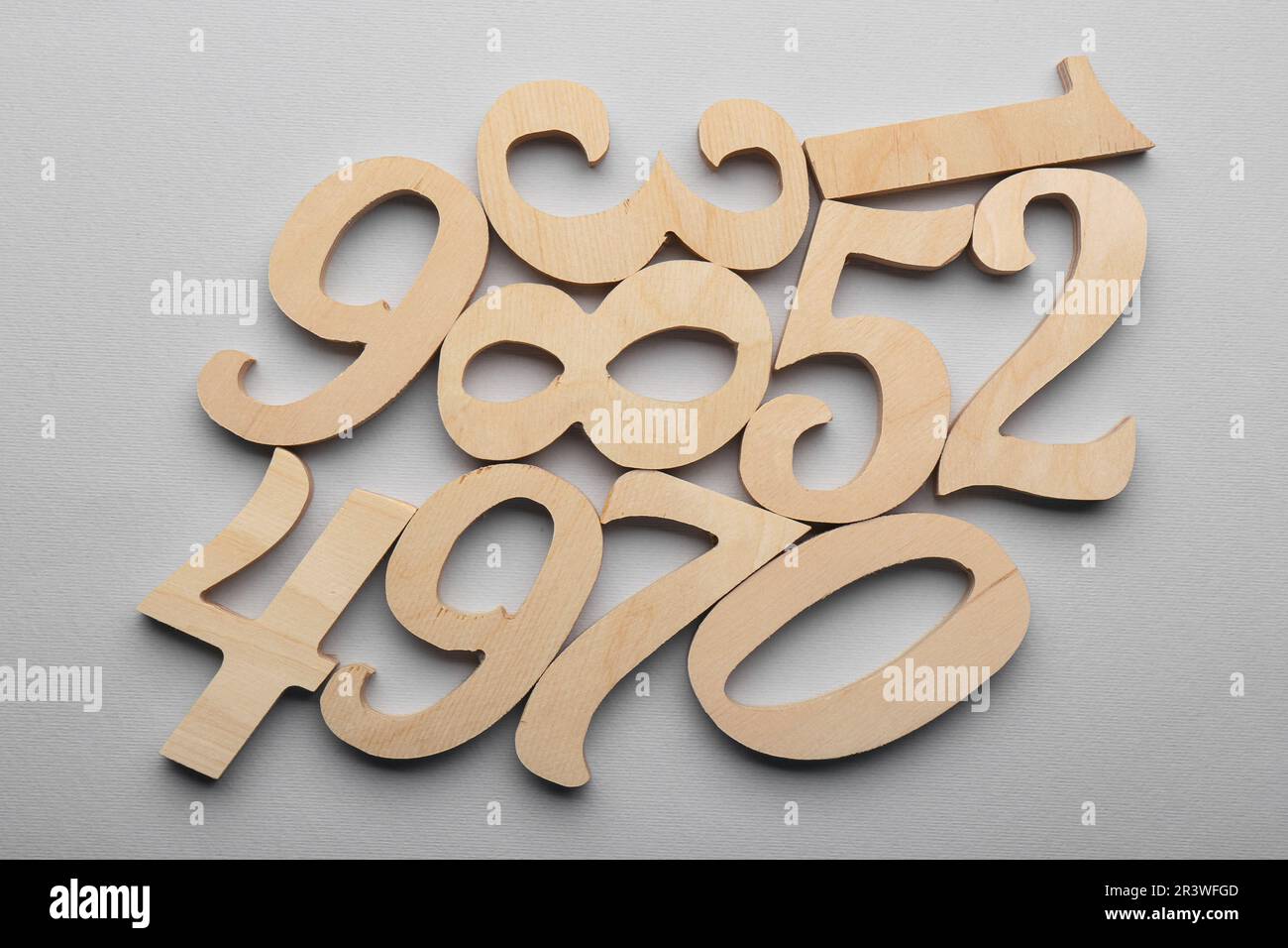 Wooden numbers on light grey background, flat lay Stock Photo - Alamy