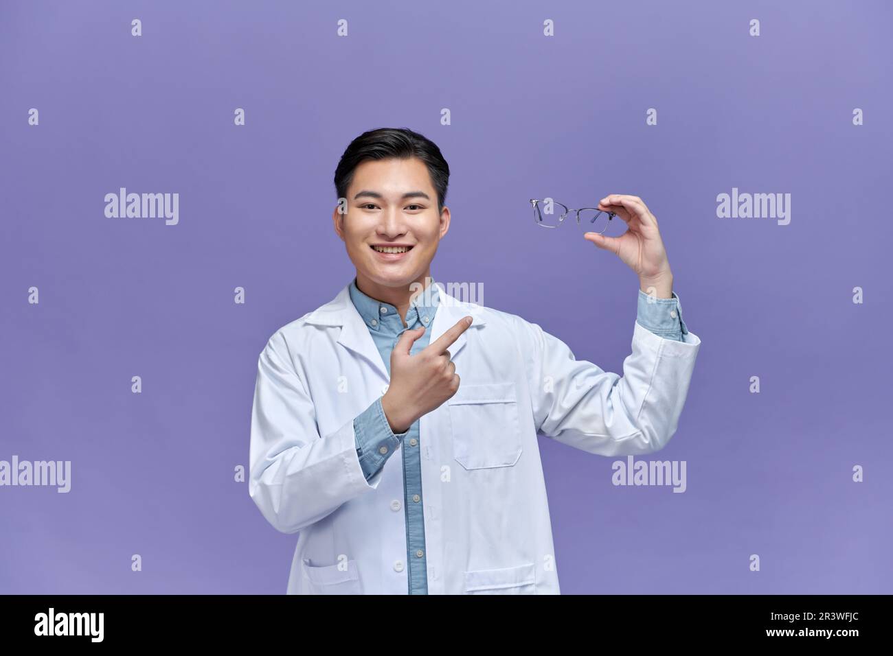 Happy asian ophthalmologist doctor holding glasses, recommending to ...