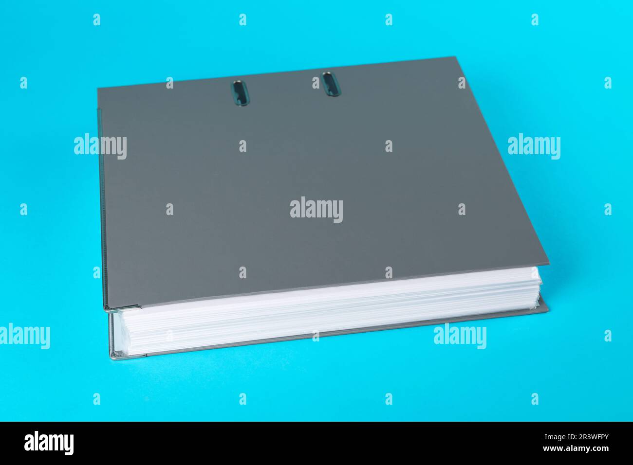 Grey hardcover office folder on light blue background Stock Photo - Alamy