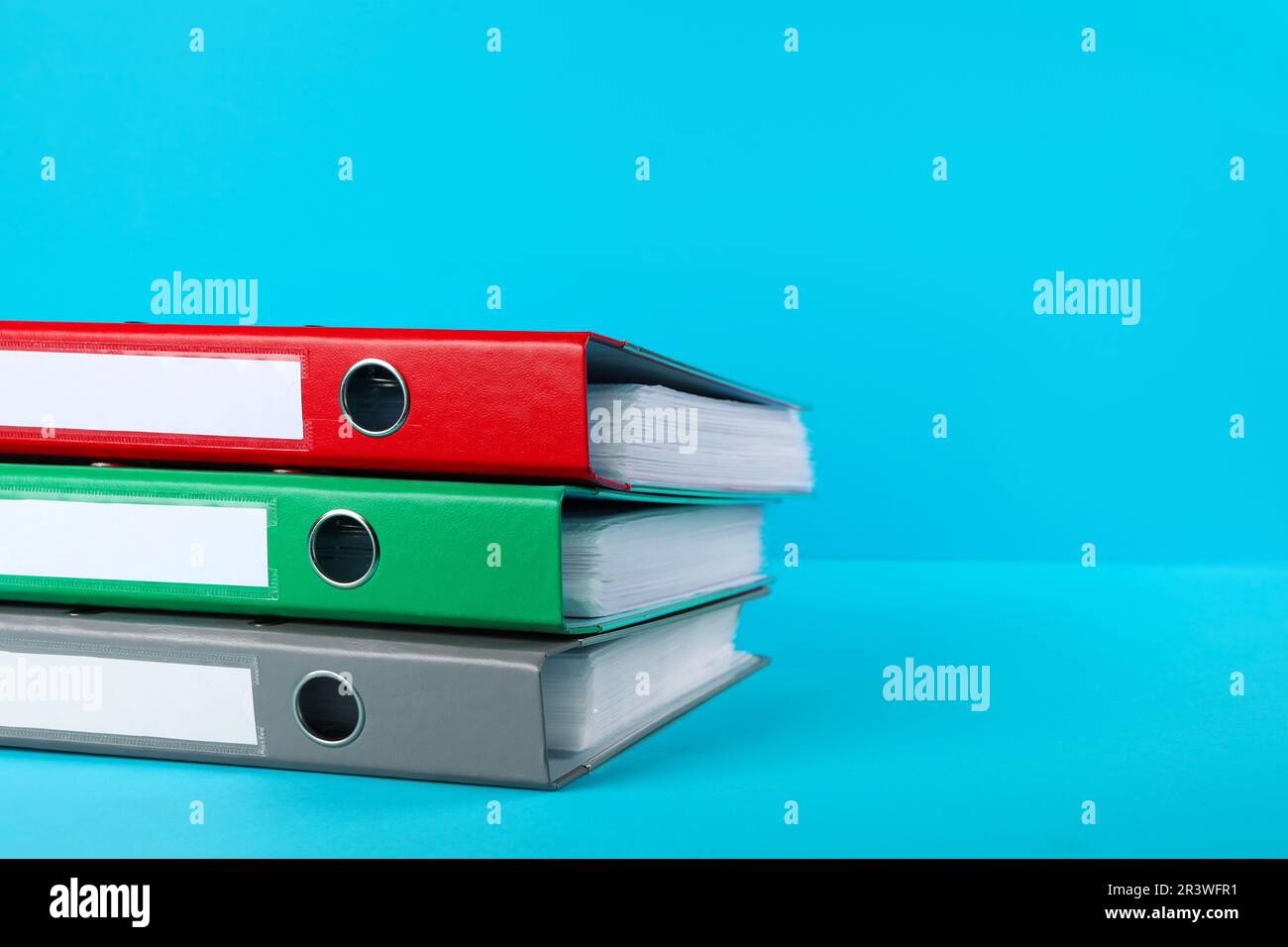 Stack of office folders on light blue background, space for text Stock ...