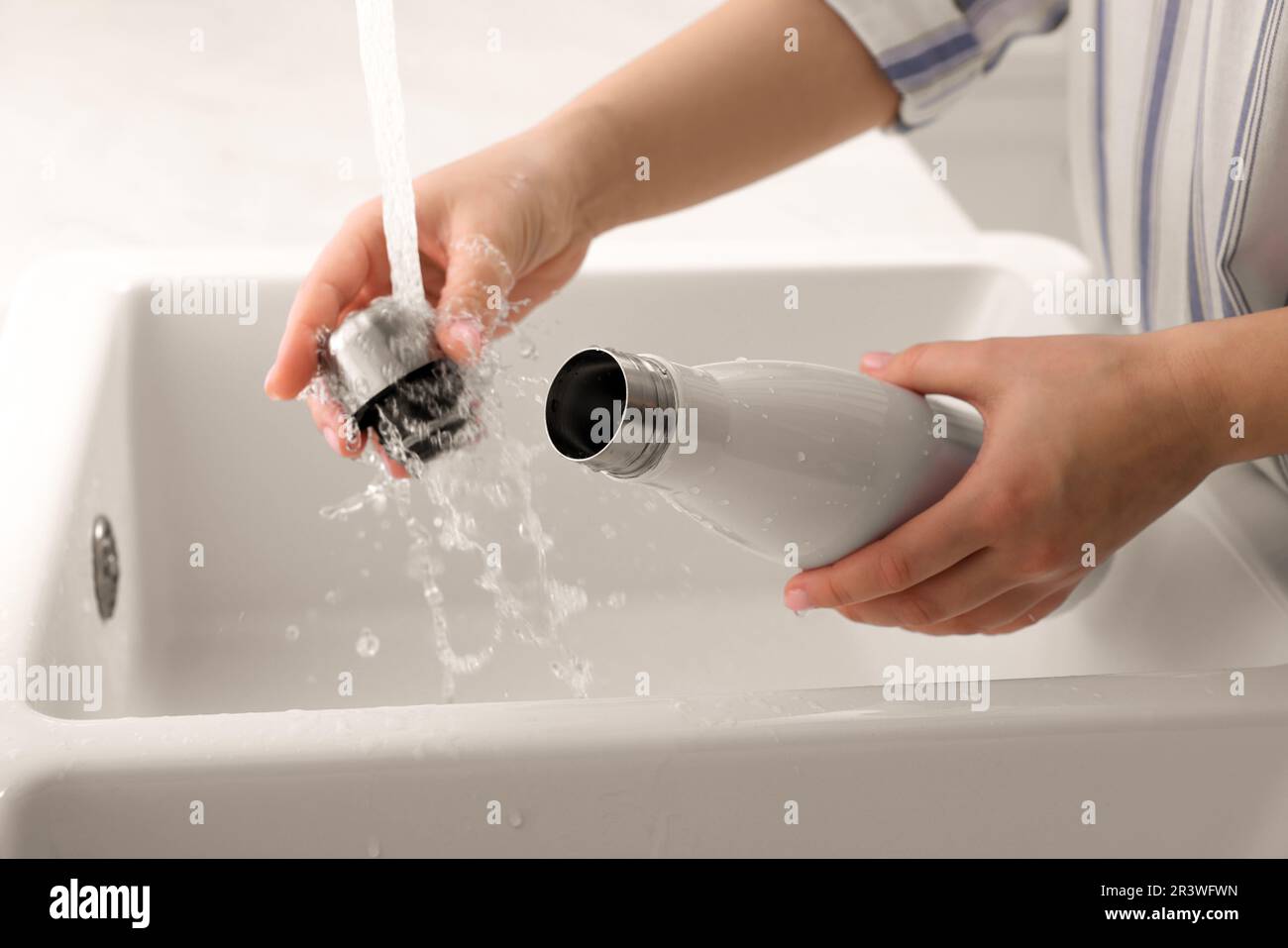Person washing metal container in hi-res stock photography and images ...