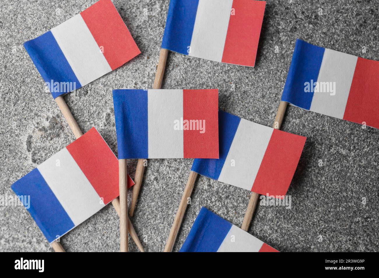 Small paper flags of France on grey table, flat lay Stock Photo - Alamy