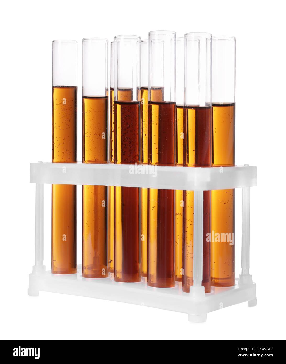 Test tubes with brown liquid in stand on white background Stock Photo ...