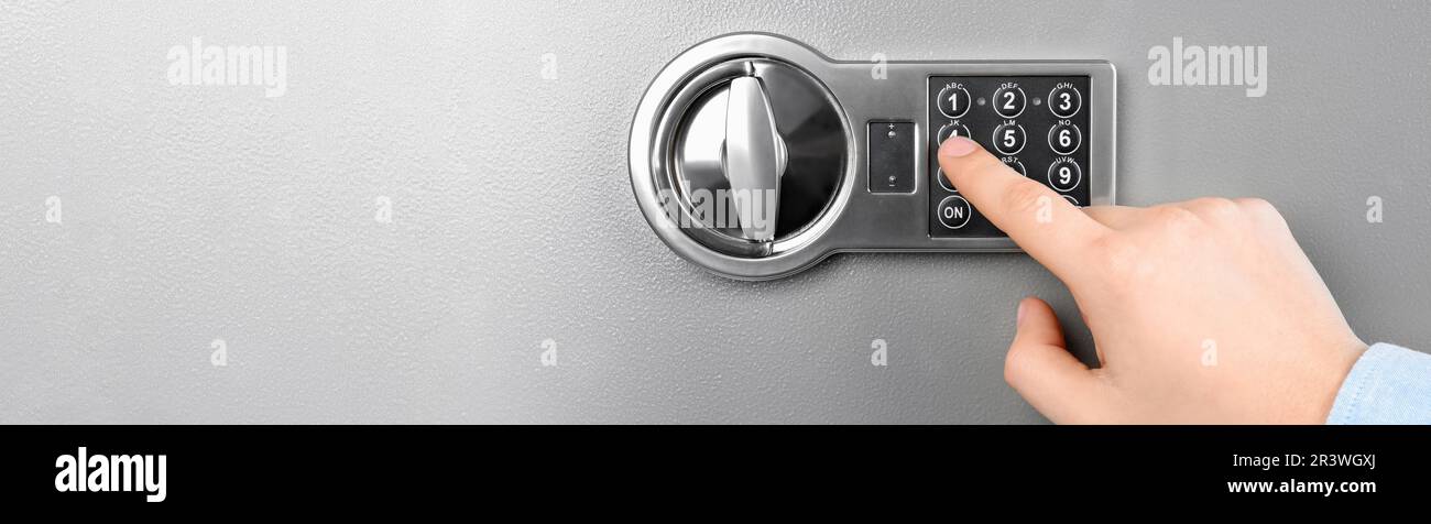 Man opening steel safe with electronic combination lock, closeup ...
