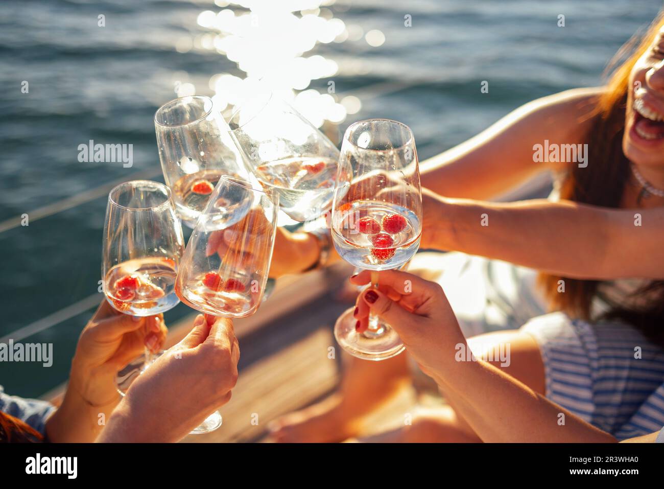 Sunset sky and sea on the background. Making a celebratory toast with ...