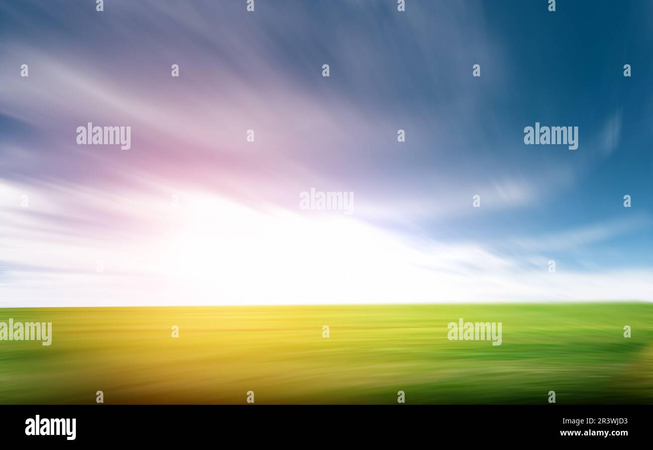 Grass and blue sky motion blur. Natural background Stock Photo - Alamy