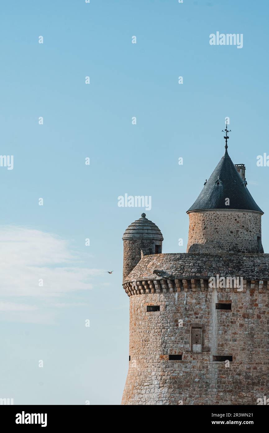 An ancient tower stands against the blue sky, a testament to its rich ...