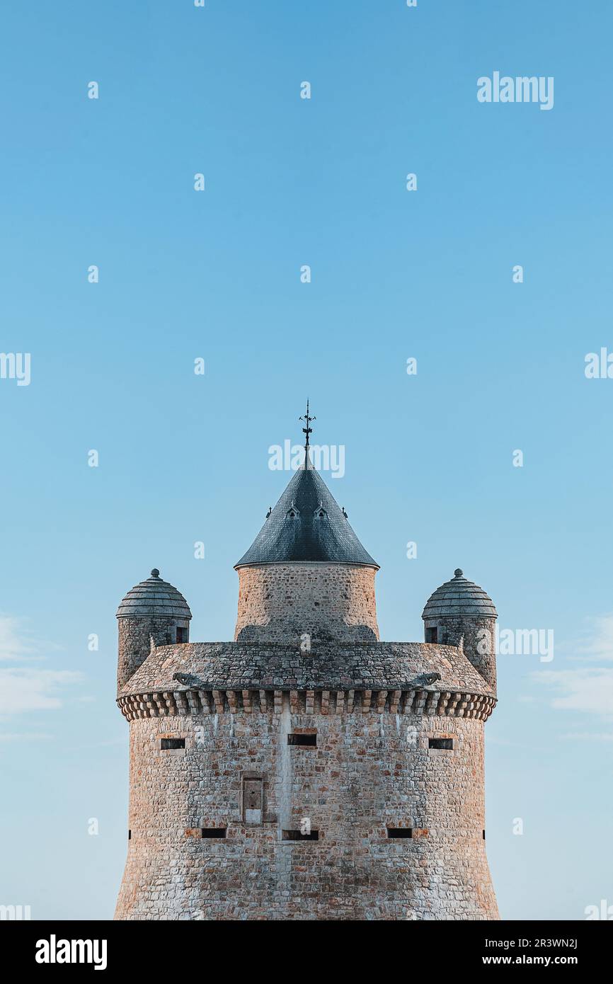 An ancient tower stands against the blue sky, a testament to its rich ...