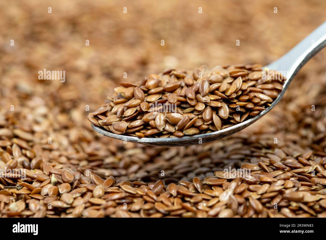Flax seeds background or texture. Flaxseed or linseed in a spoon. cereals healthy food. Close up ...