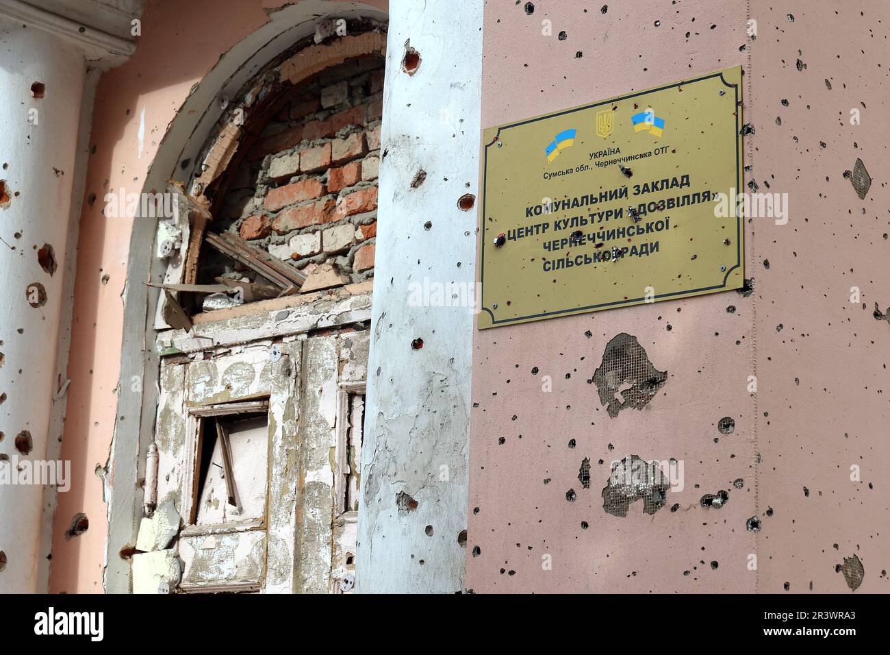 OKHTYRKA, UKRAINE - MAY 24, 2023 - Shrapnel holes dot the wall of a ...