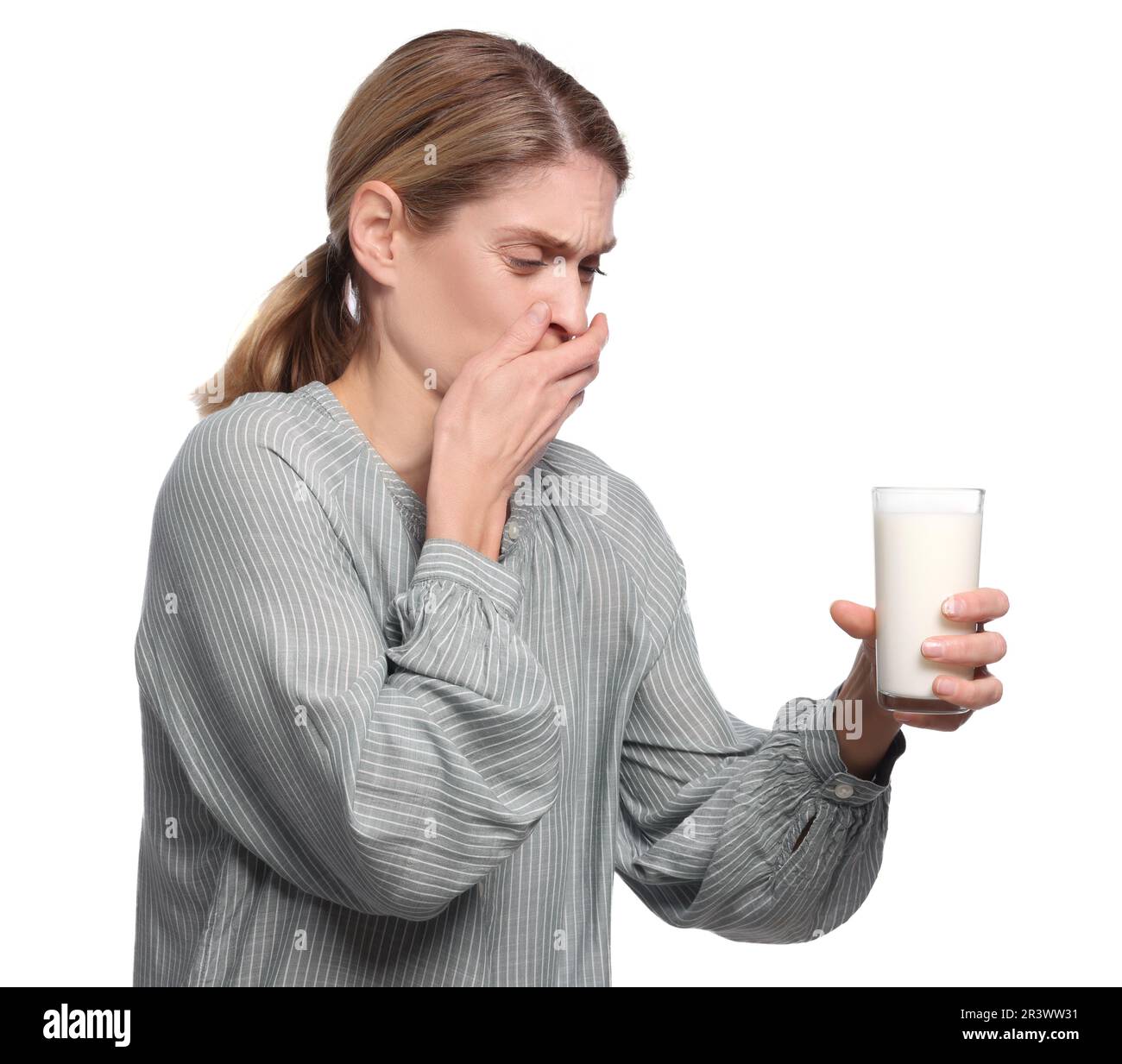 Woman with glass of milk suffering from lactose intolerance on white ...