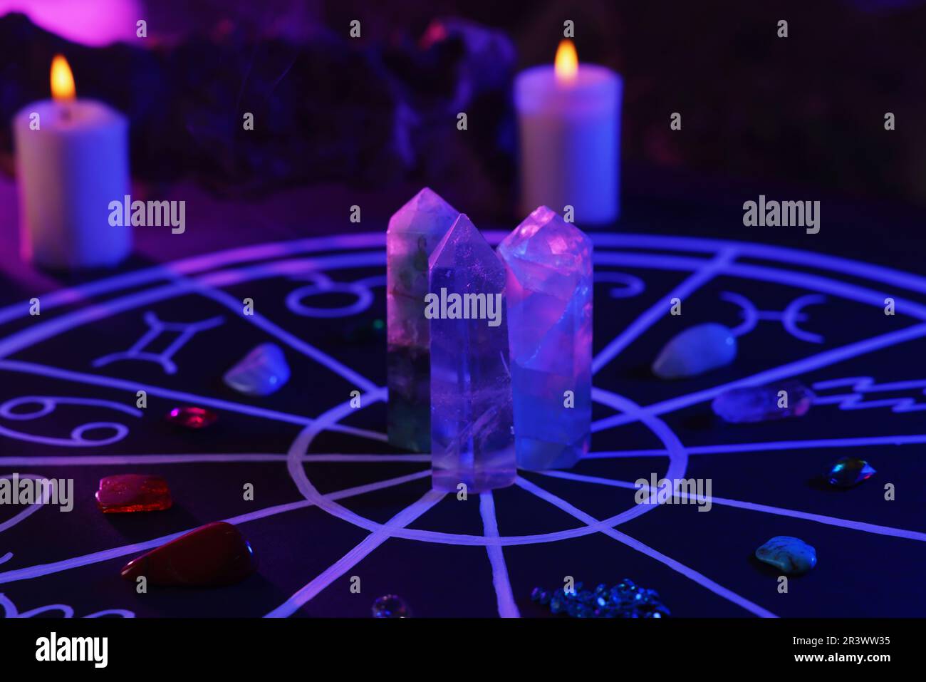 Natural stones for zodiac signs, drawn astrology chart and burning ...