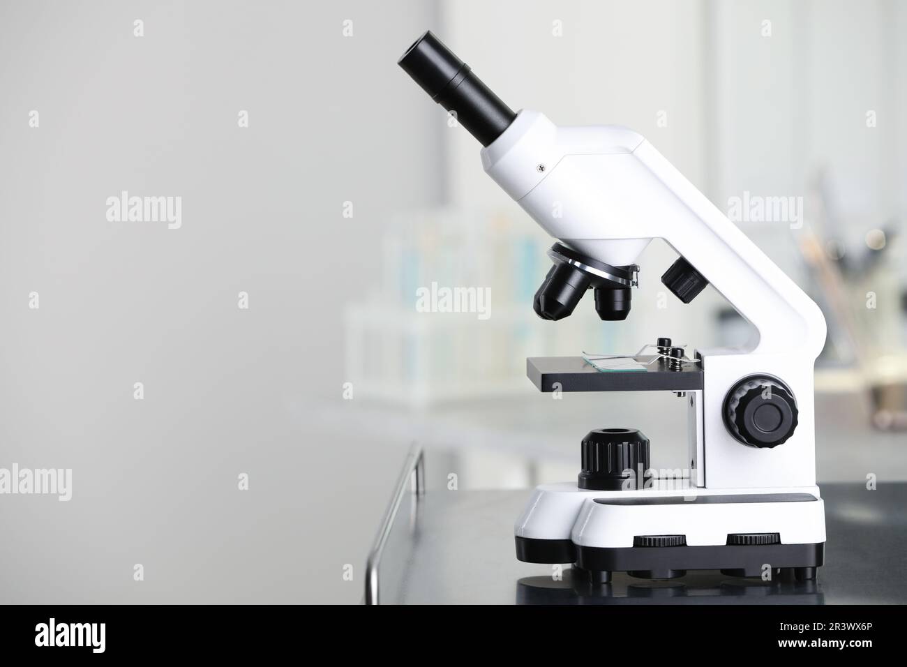Modern medical microscope on metal table in laboratory Stock Photo - Alamy