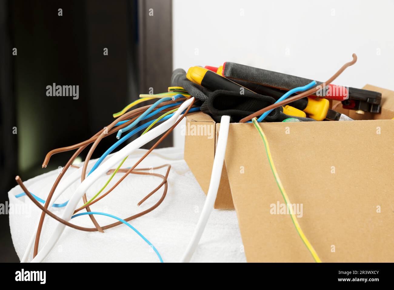Different tools and cables in paper indoors. Installation of electrical ...