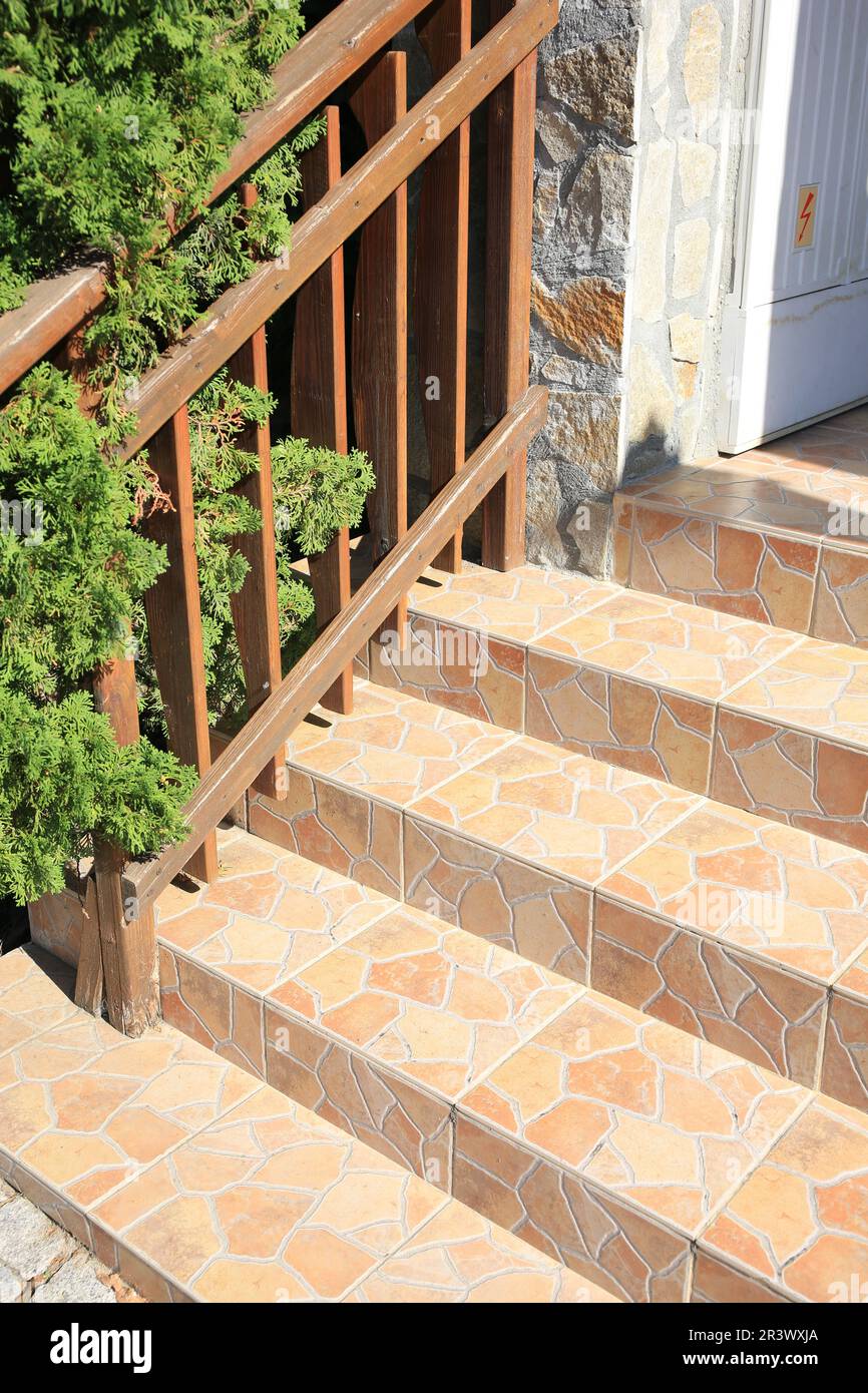 View of beautiful stone stairs with metal handrail near house outdoors ...