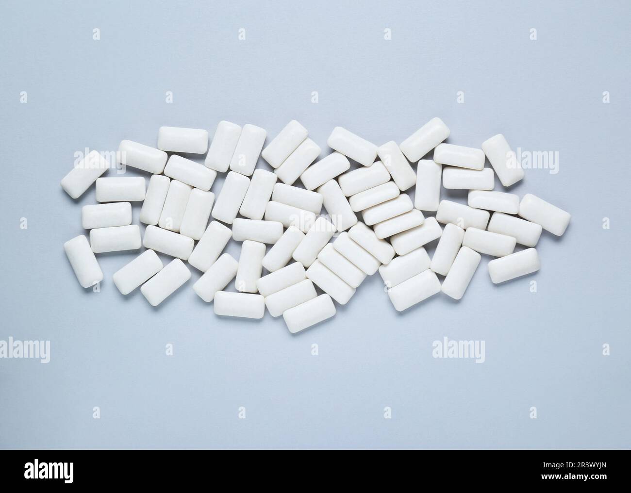 Tasty white chewing gums on light grey background, flat lay Stock Photo ...
