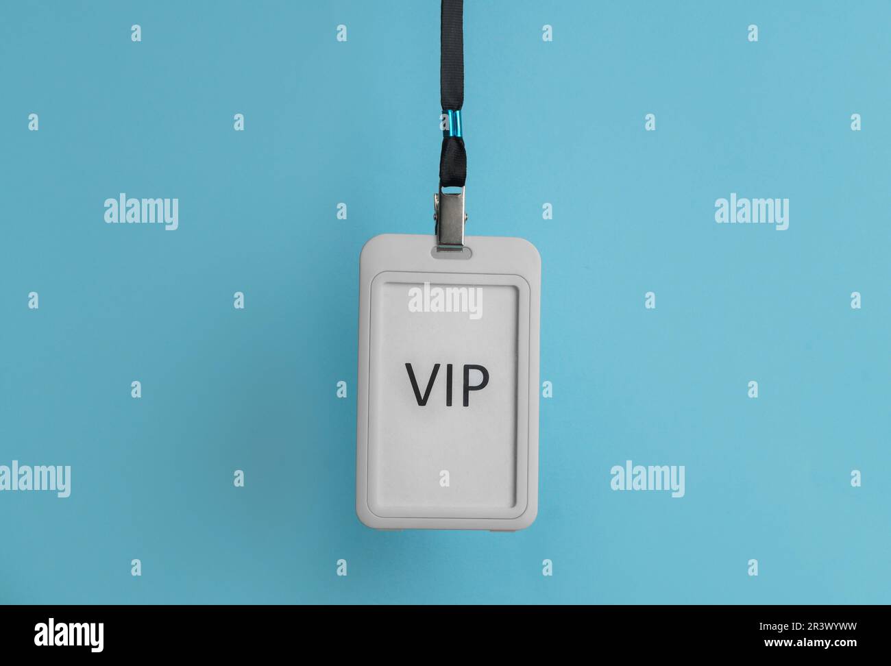 Plastic vip badge hanging on light blue background Stock Photo - Alamy