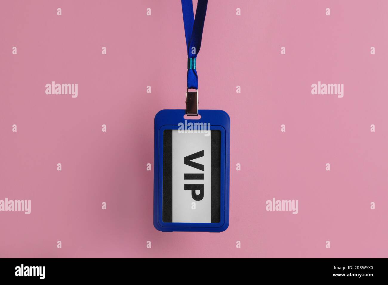 Plastic vip badge hanging on pale pink background Stock Photo - Alamy